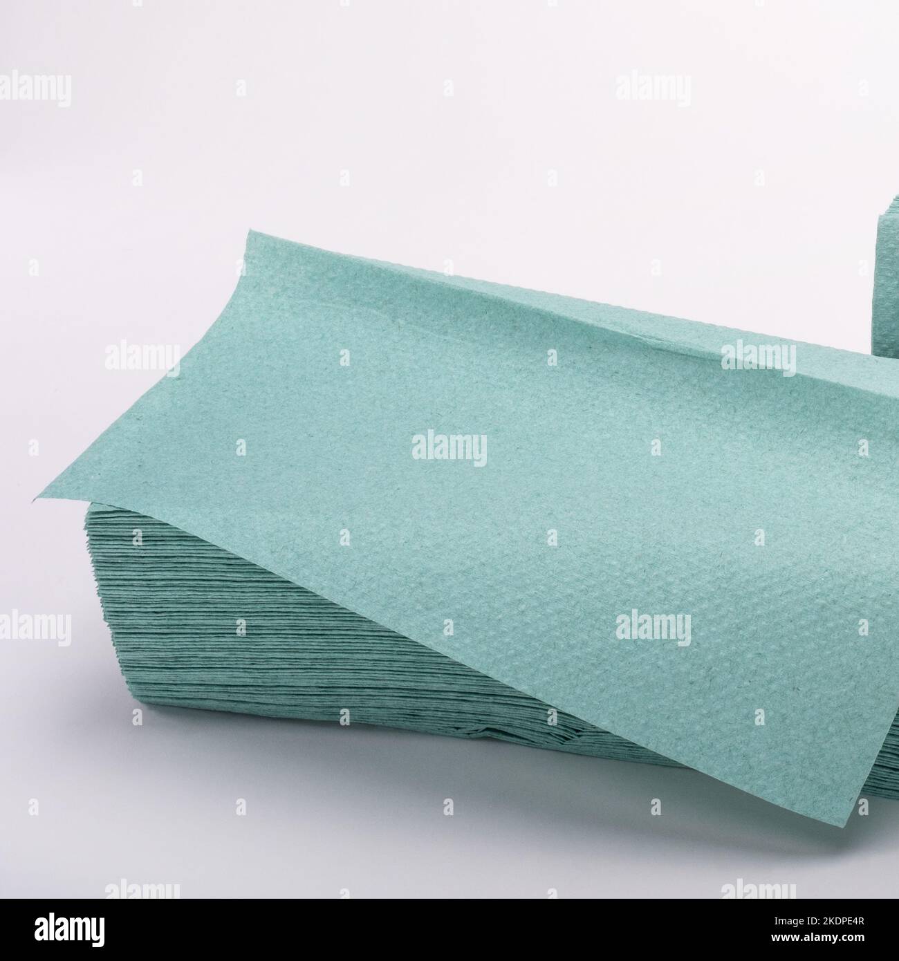 Green paper towels pile on a white background. Pack of paper napkins ...