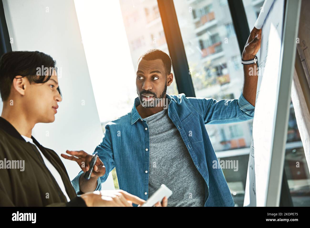 Just imagine if this worked. two young businessmen brainstorming with a ...