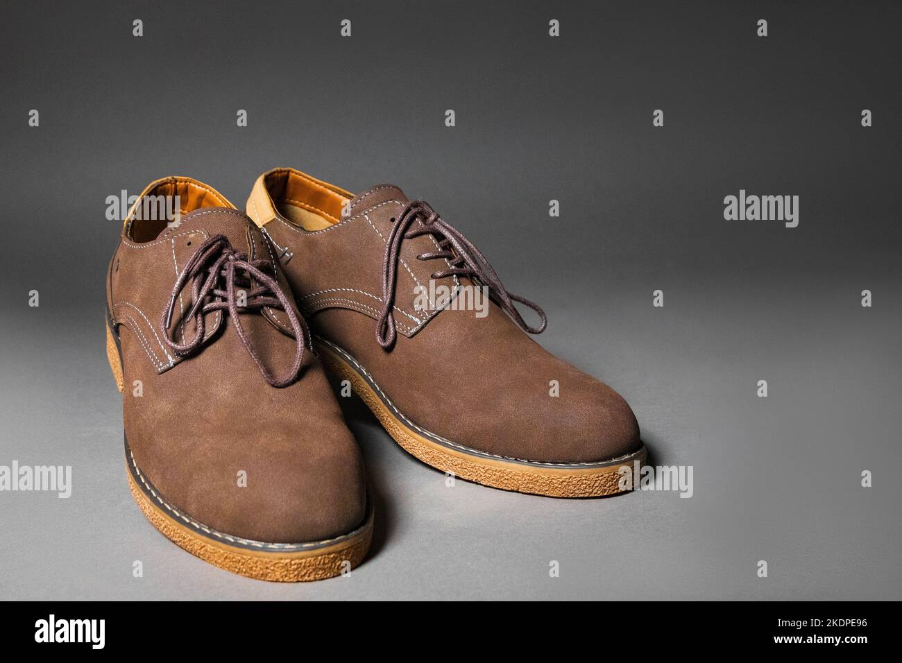 Pair of men's brown suede shoes on grey background Stock Photo - Alamy