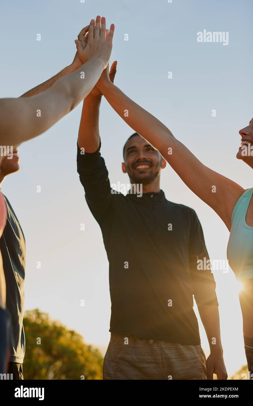 Work hard and be proud of yourself. a fitness group giving each other a ...