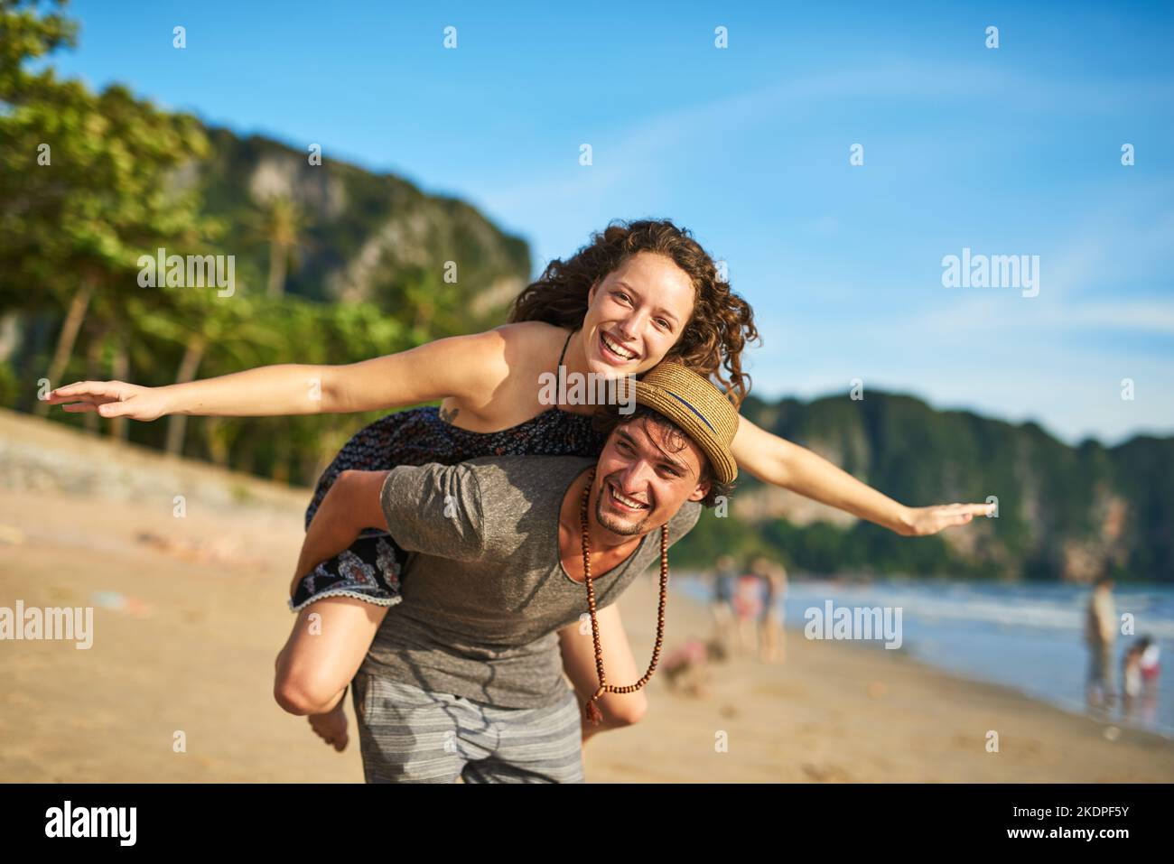 Love means having fun together. Portrait of a happy young man giving ...