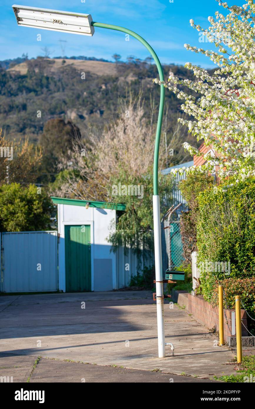 A letterbox strapped to an old fluorescent light power pole in the main ...