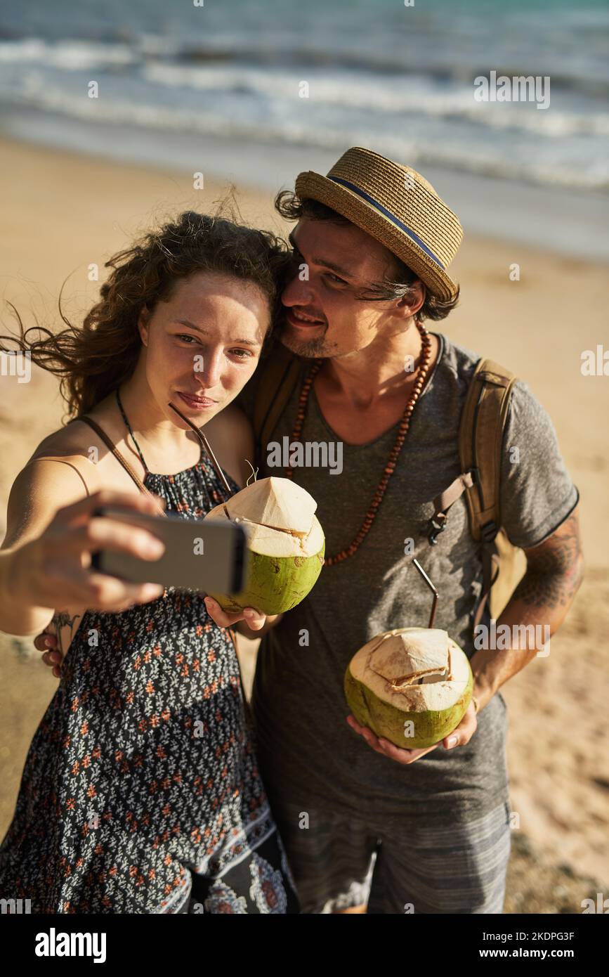 Our friends will be so jealous. a happy young couple taking selfies ...