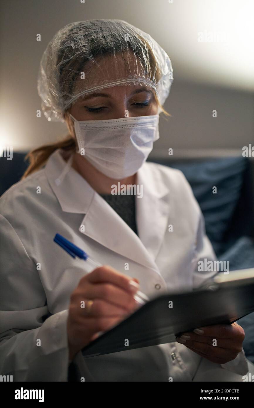 Doctor filling out a document. Hospital staff working at night duty ...