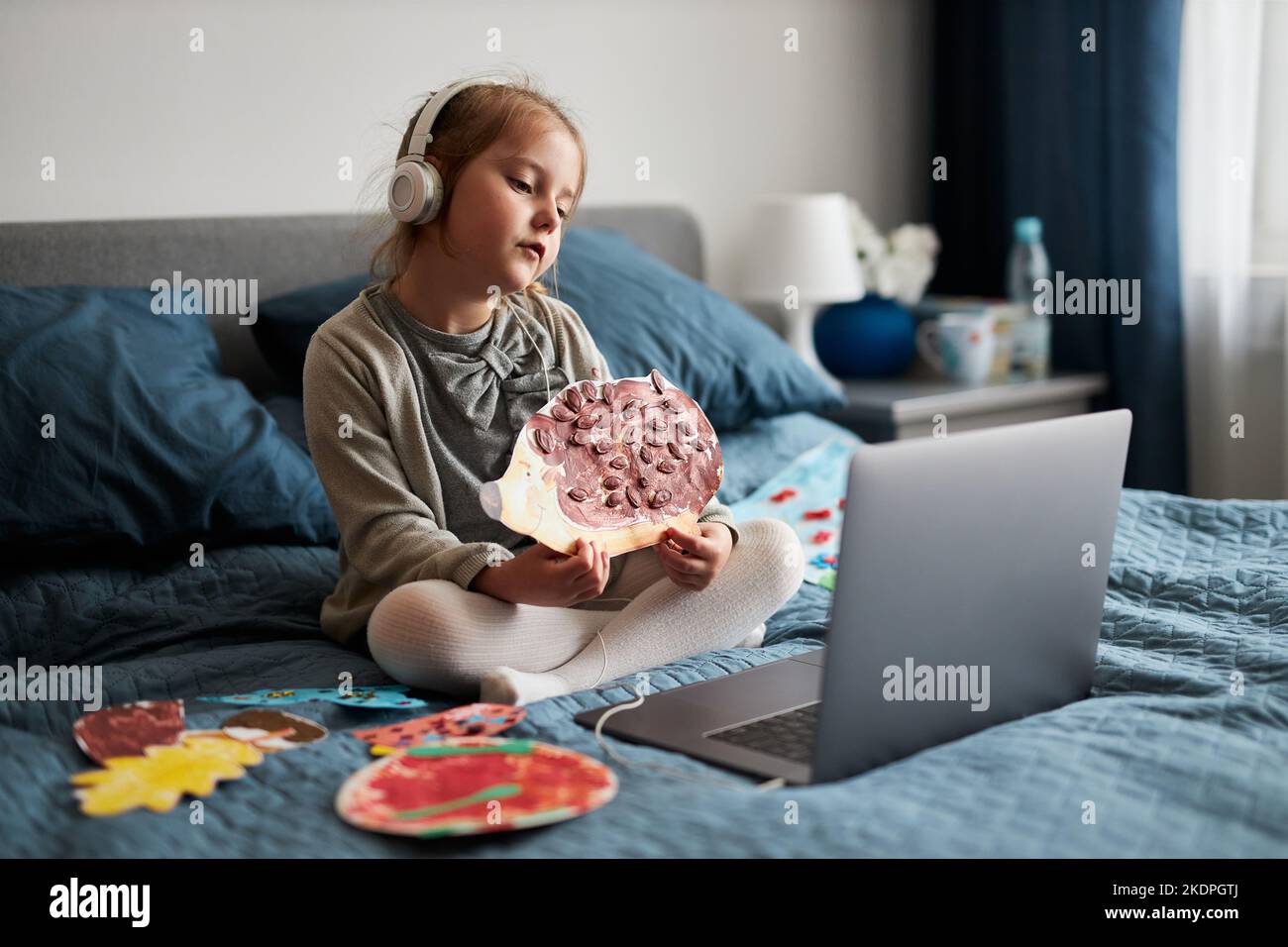 Little girl preschooler learning online showing her works drawings done ...