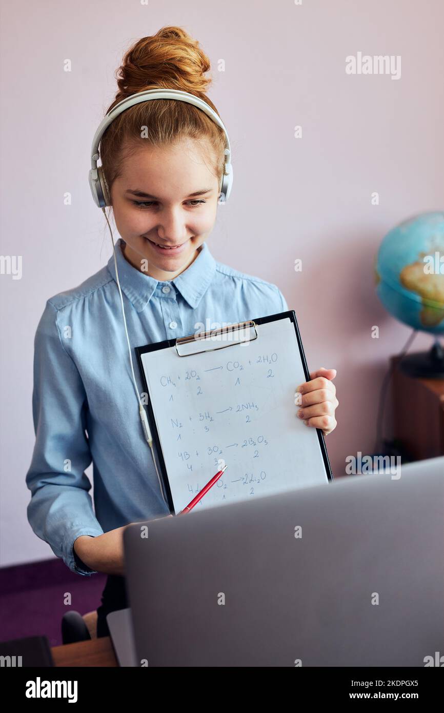 Young woman student showing homework, having classes, learning online ...