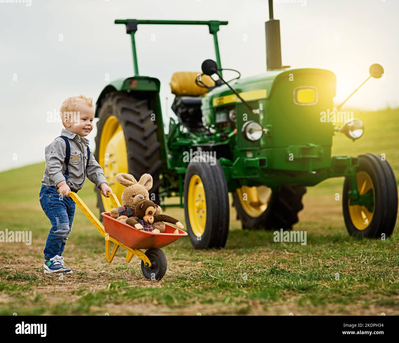 Rounding up the livestock like a champ. an adorable little boy pushing ...