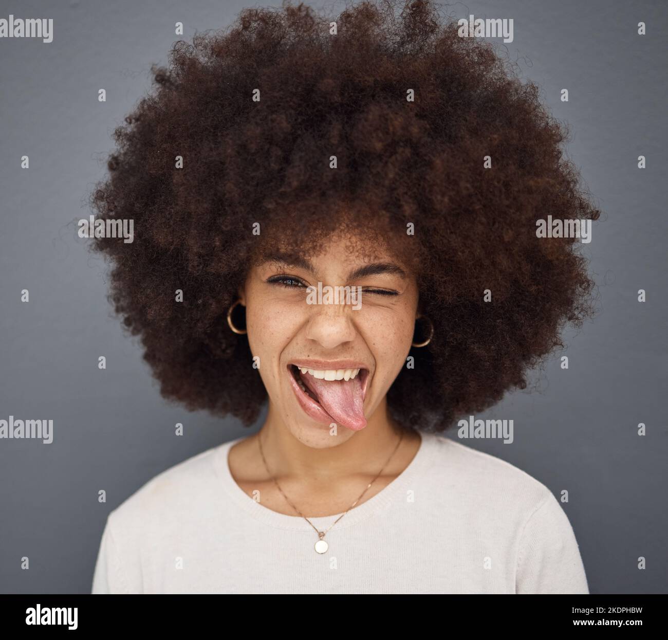 Goofy, face and woman with her tongue out in studio with comic, fun and crazy facial expression ...