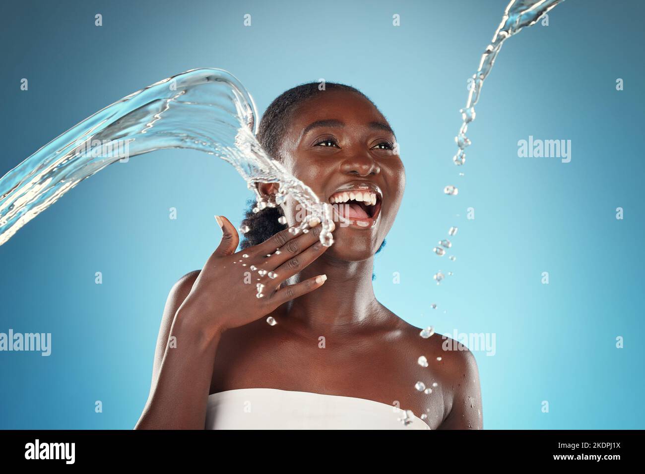 Water splash, laughing black woman and beauty on blue background of skincare, wellness or body ...