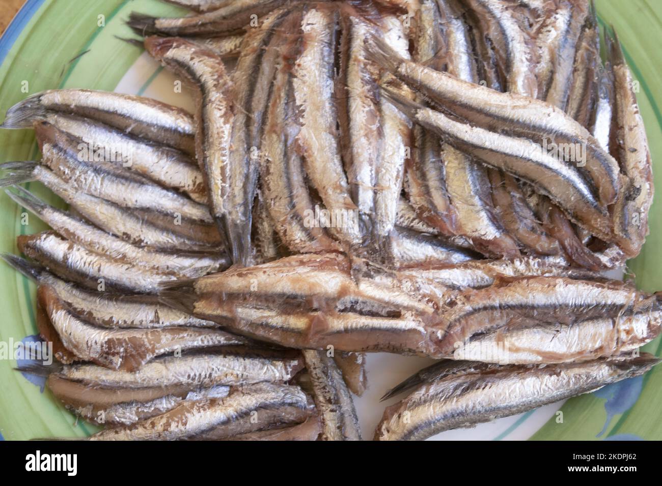 colored dish with anchovies while defrosting Stock Photo - Alamy