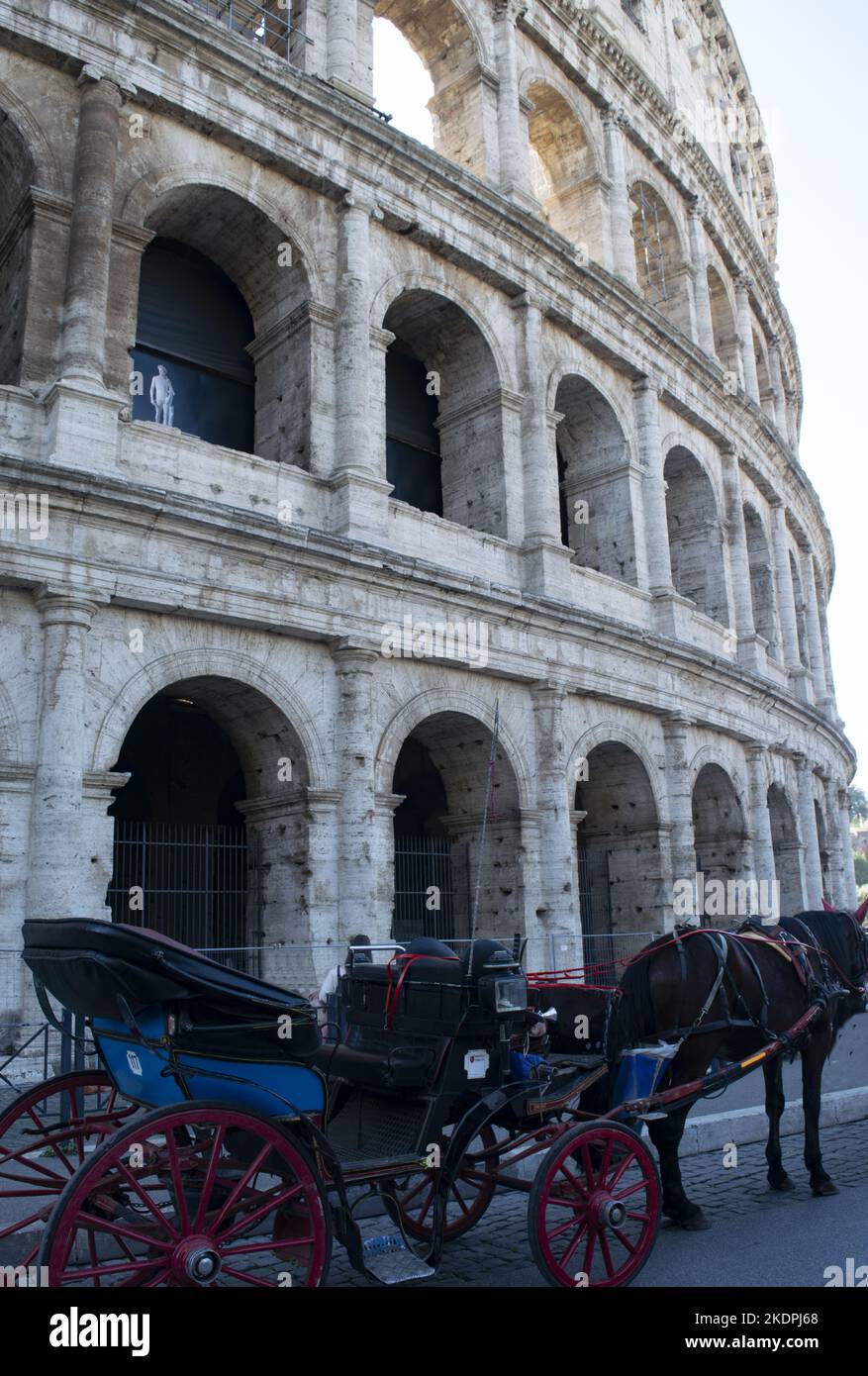 the Colosseum in Rome seen through the typical horse-drawn carriage ...
