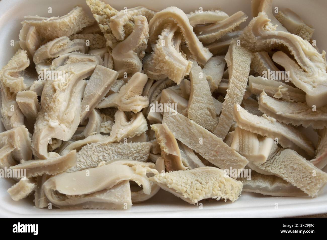 raw tripe cut into strips in a plastic tray Stock Photo - Alamy