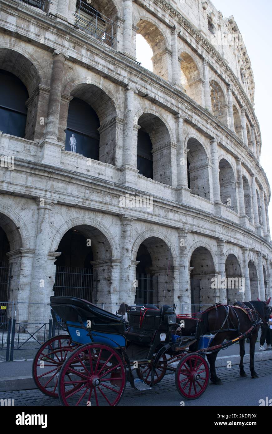 the Colosseum in Rome seen through the typical horse-drawn carriage ...