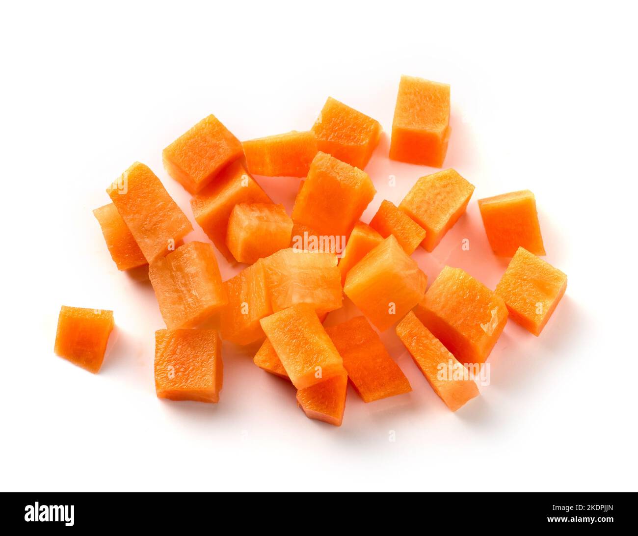 heap of fresh raw carrot cubes isolated on white background, top view ...