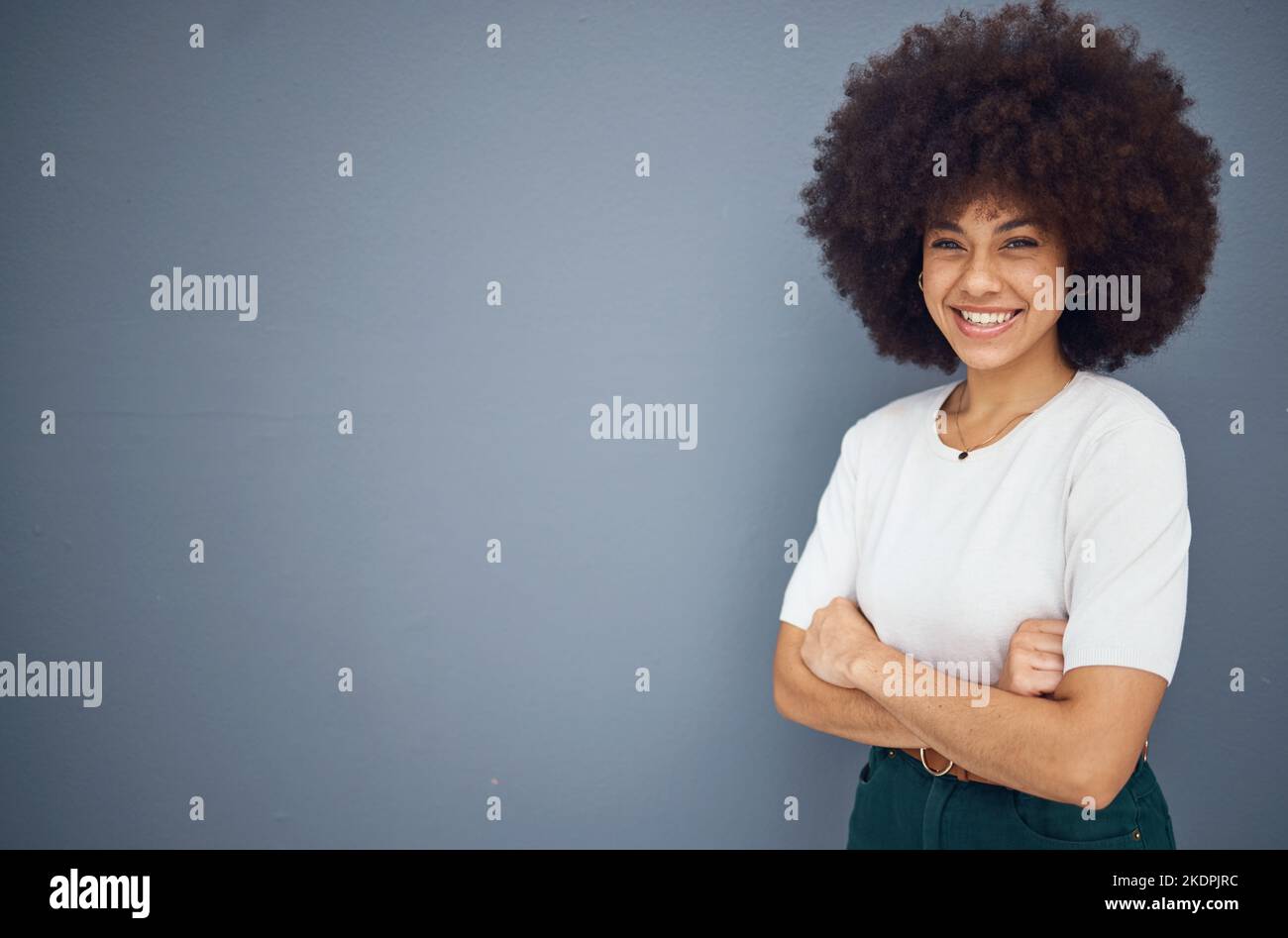 Black woman, afro or arms crossed by advertising space on grey studio ...