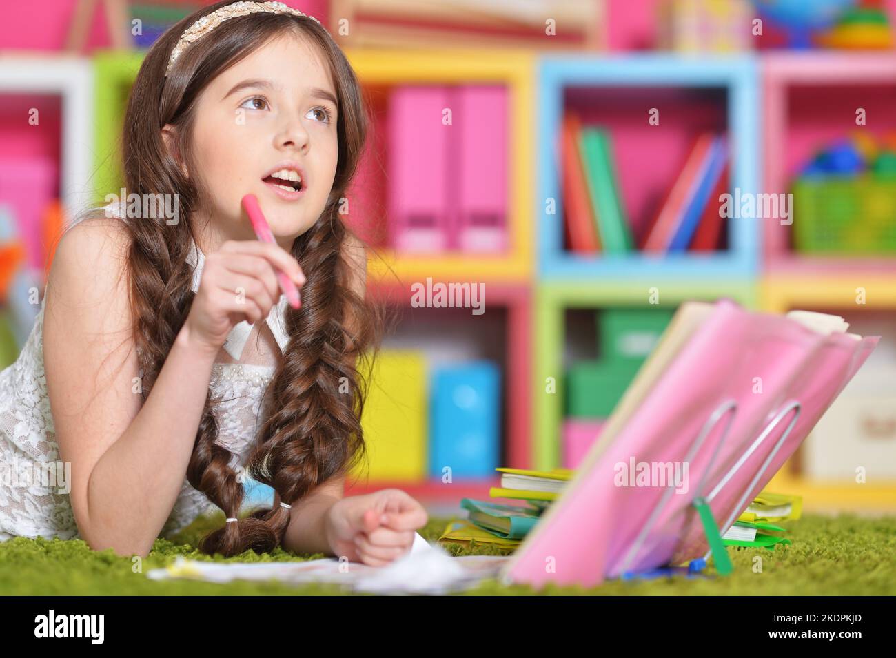 Portrait of cute little girl study at home Stock Photo - Alamy