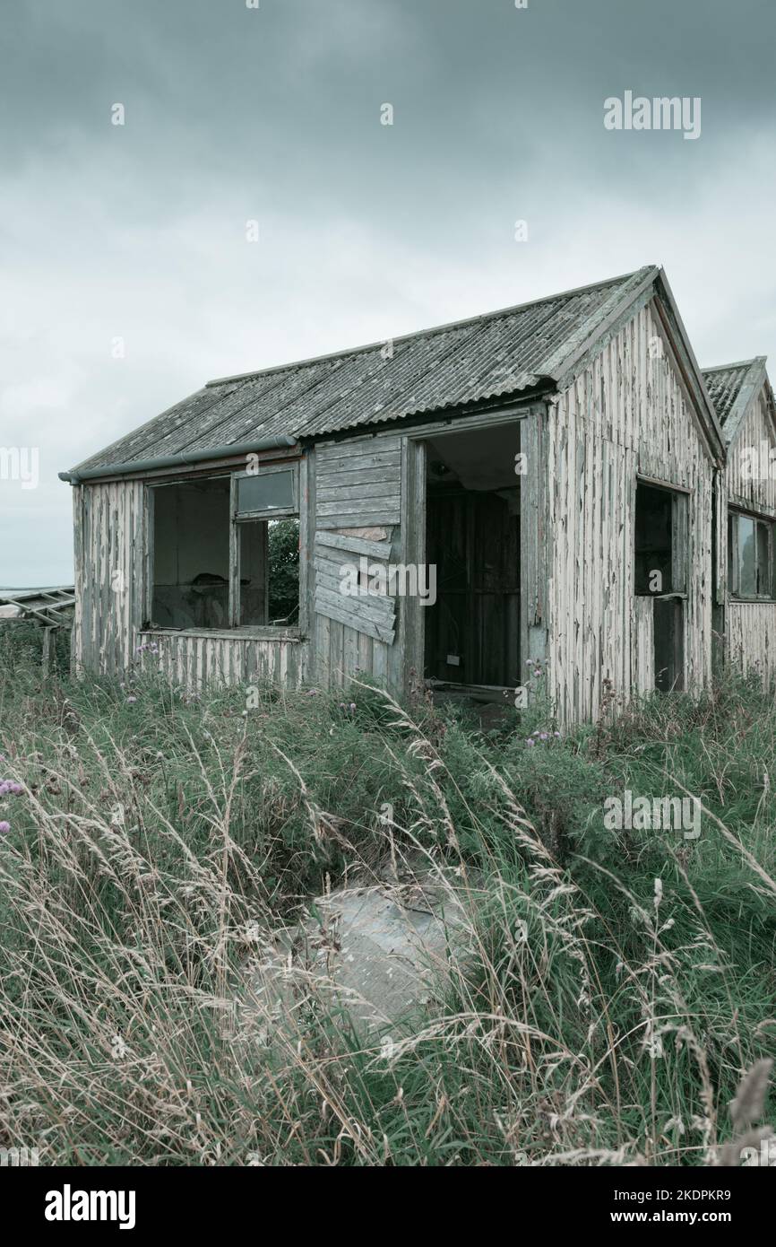 Old abandoned huts with an eerie spooky atmosphere Stock Photo - Alamy