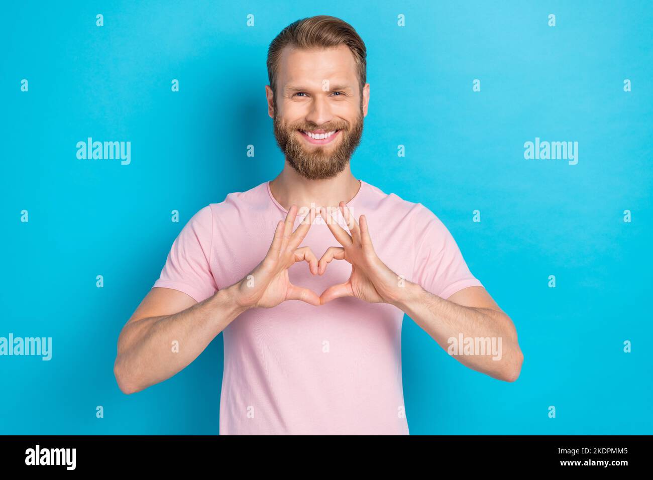 Photo of charming adorable young man wear pink t-shirt showing arms ...