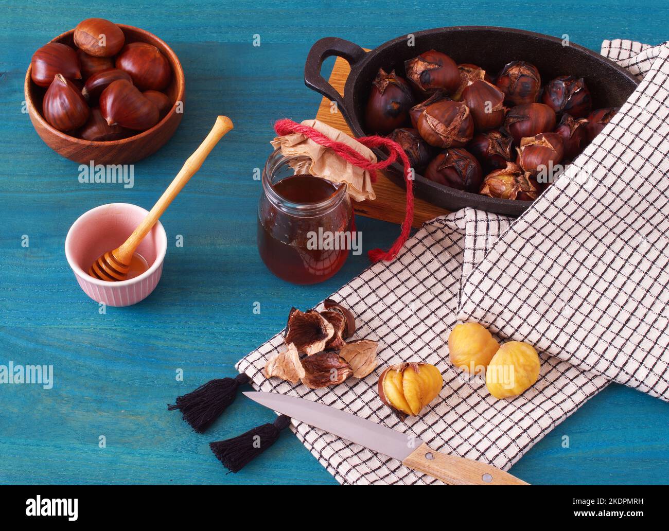 Roasted edible chestnut with honey on blue wooden background. High ...