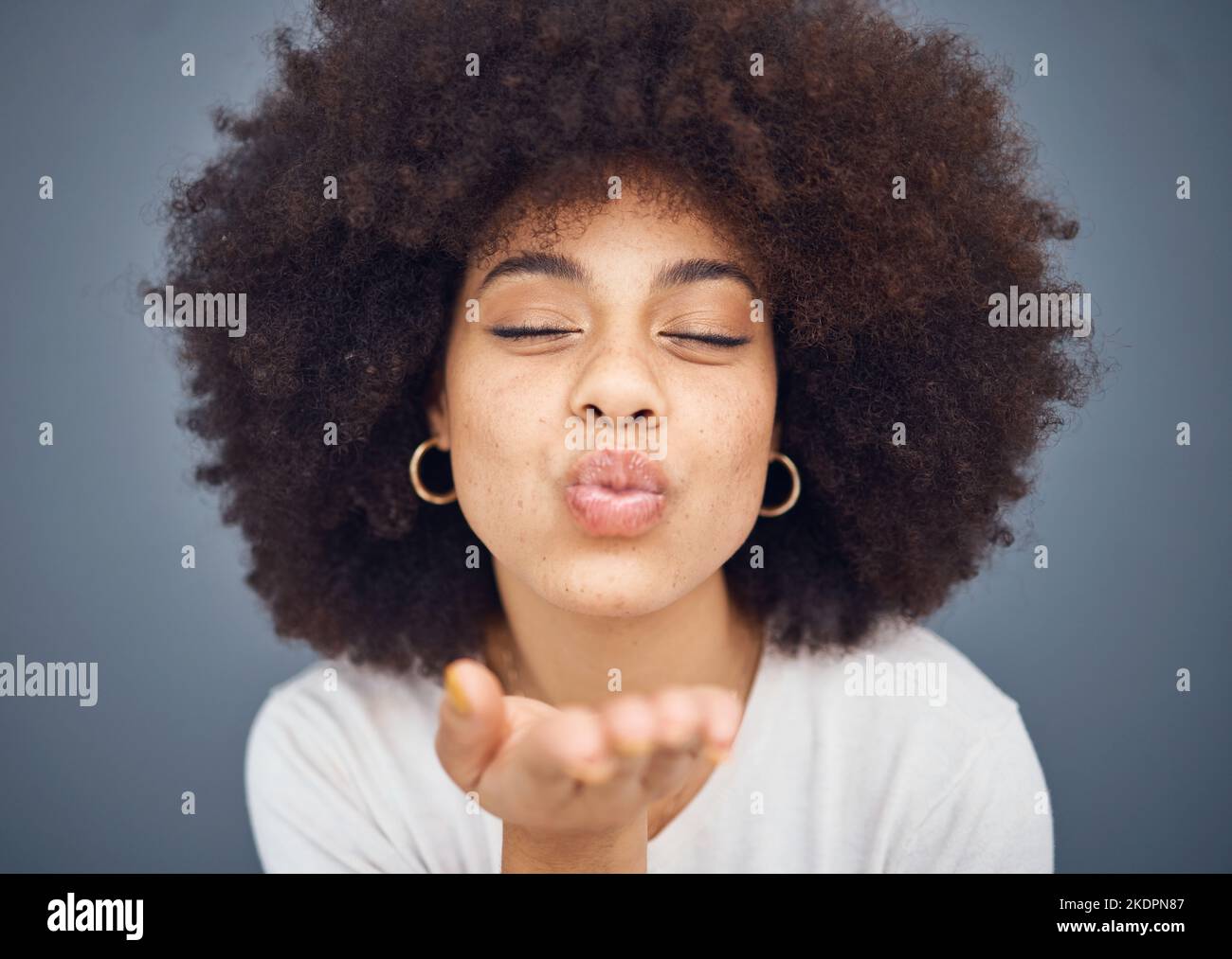 Kissing, love and romance with a black woman blowing a kiss in studio ...