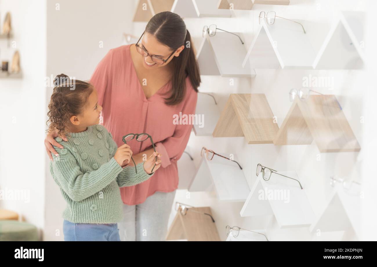Glasses, vision and mother with child in optometry shop with choice or ...