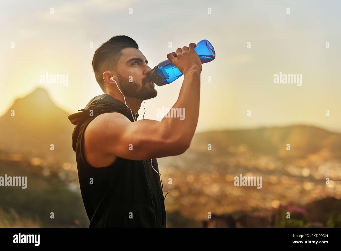 That work out made me thirsty. a young man exercising outdoors Stock ...