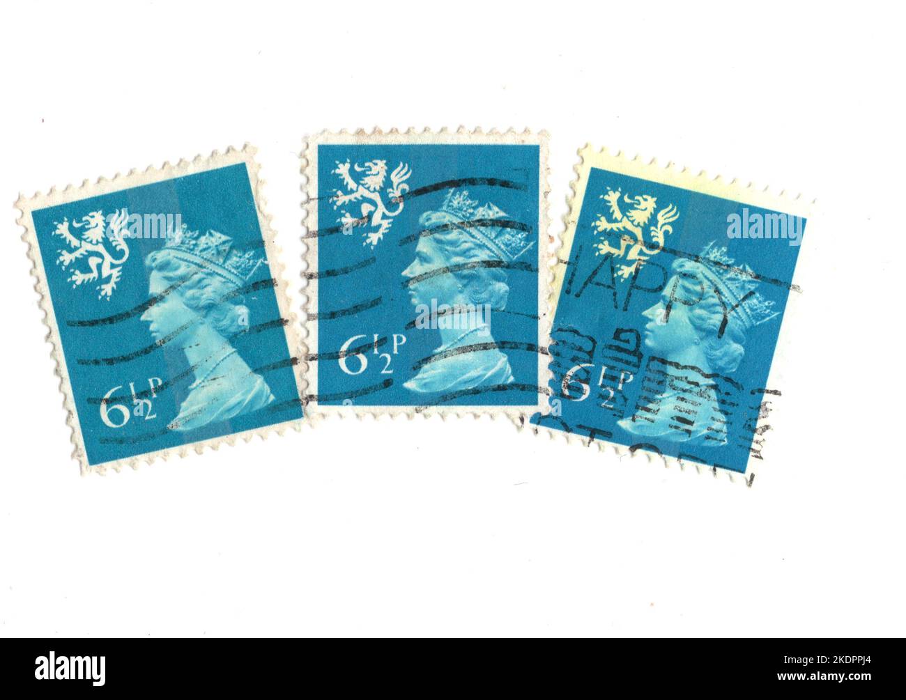 A montage of vintage postage stamps from the United Kingdom on a white ...