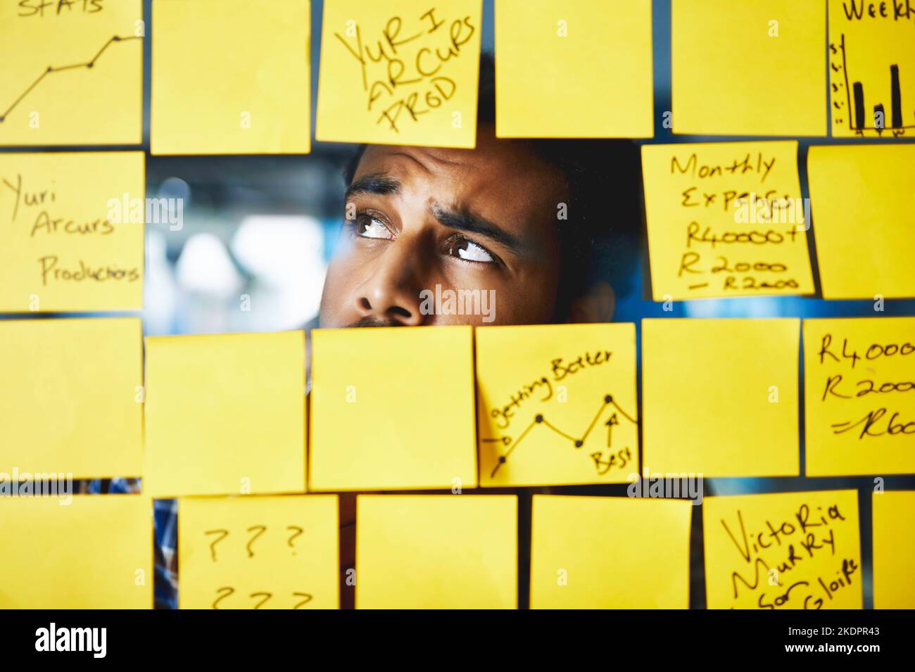 Is it about quality or quantity. a young man having a brainstorming ...