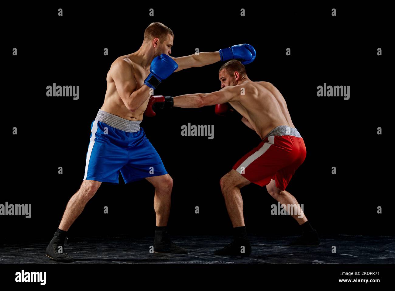 Fight. Dynamic portrait of two professional boxer in sports uniform ...