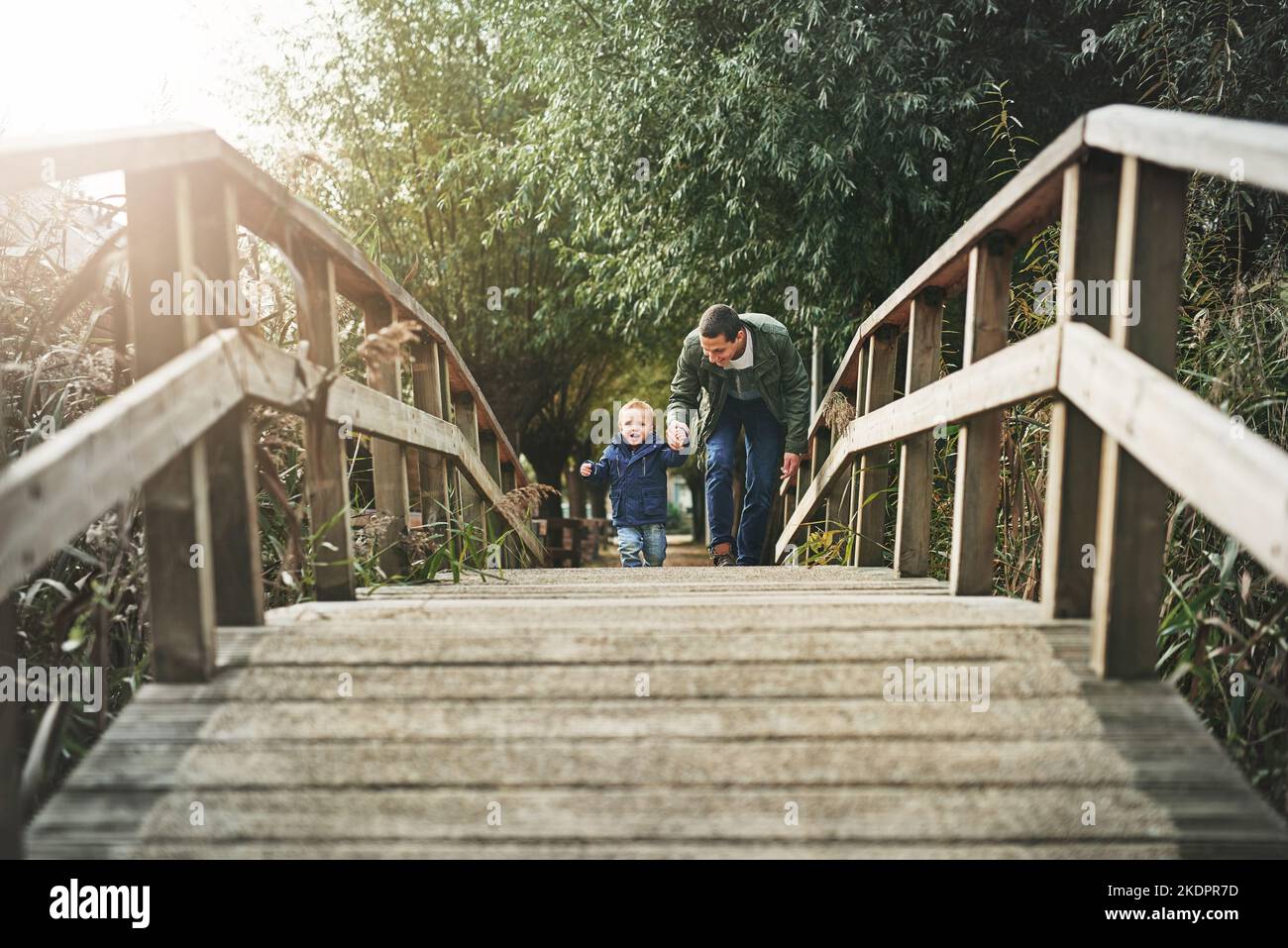 Following the path to the park. a father bonding with his son outside ...