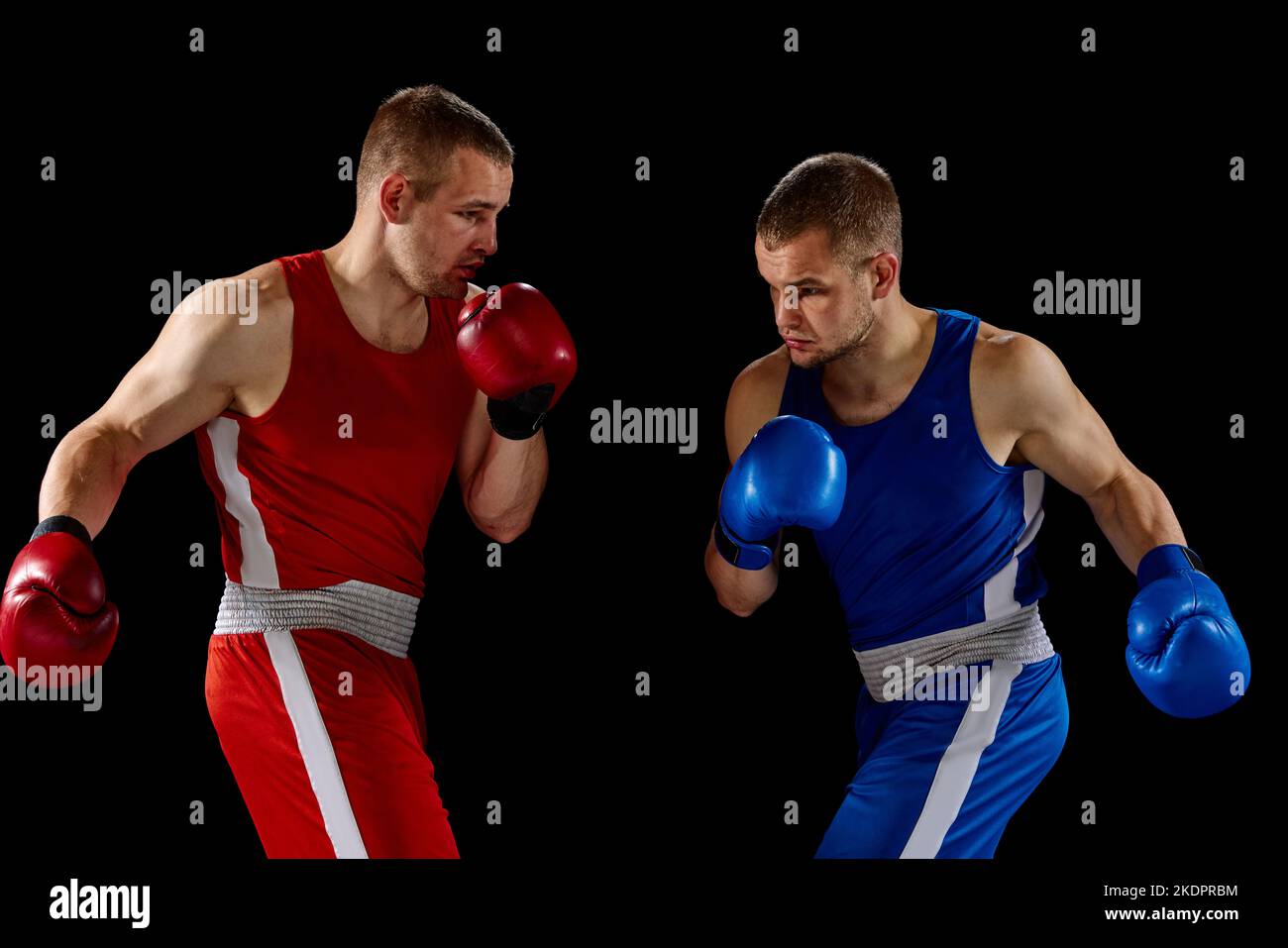 Male professional boxers in blue and red sports uniform practicing ...