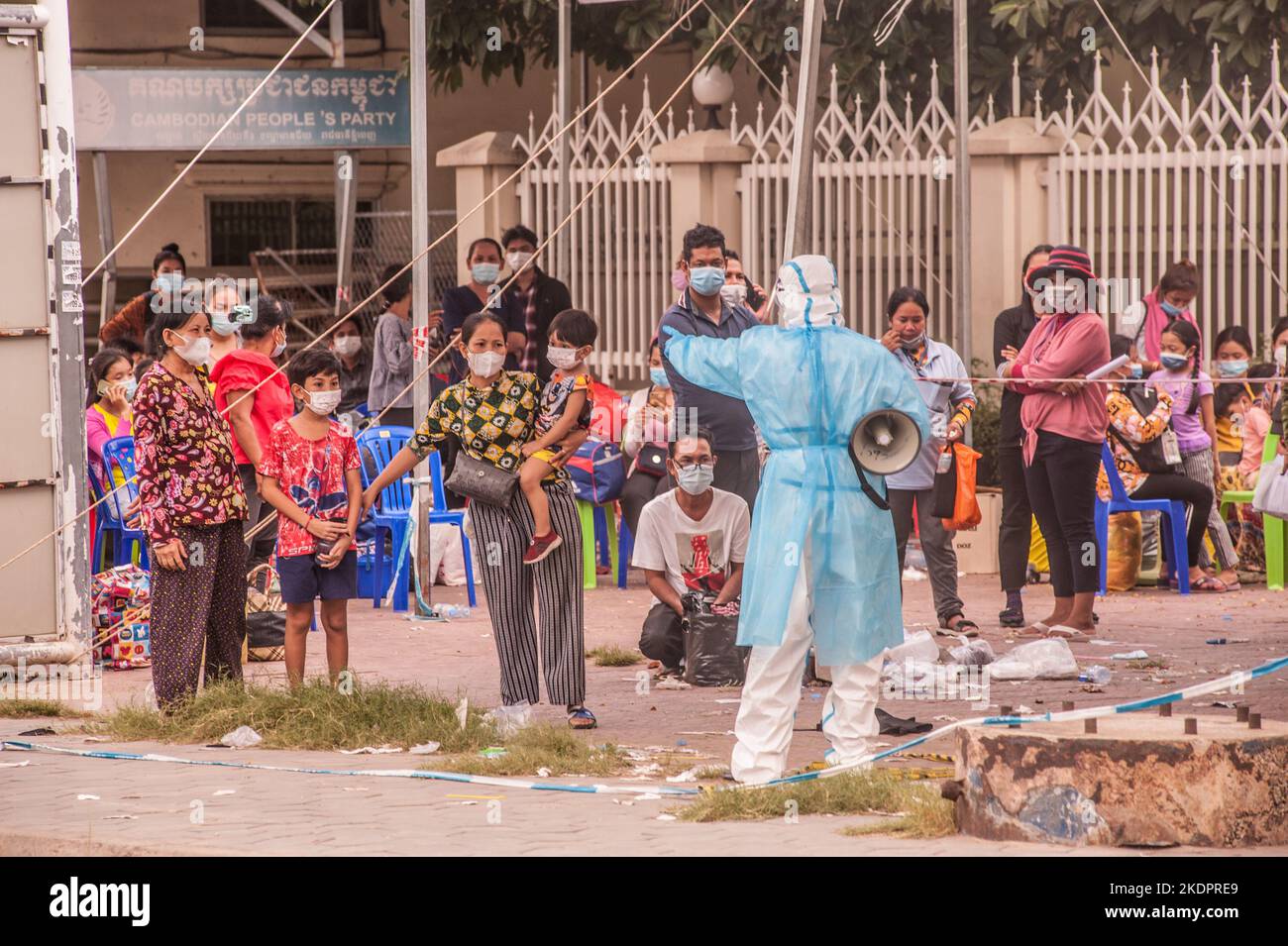 an EMT directs a mass testing site. a Cambodian mother & her two small ...