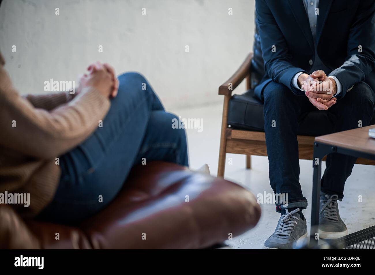 Man and woman sitting opposite each other and talking Stock Photo - Alamy