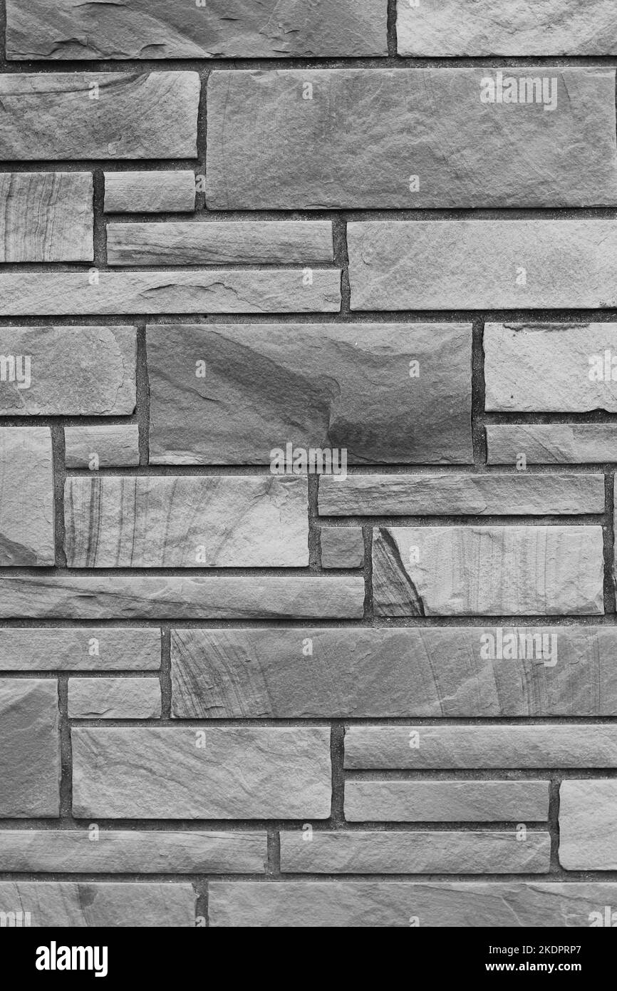 Solid brick wall created with natural stone bricks in a random pattern ...