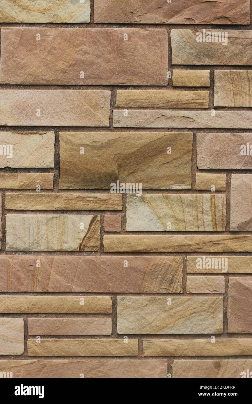 Solid brick wall created with natural stone bricks in a random pattern ...