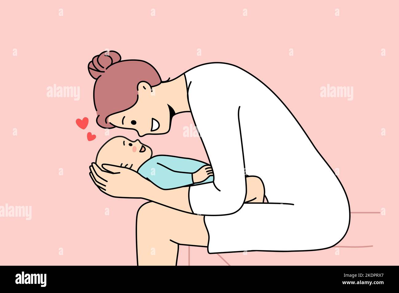 Happy loving young mother playing with newborn baby. Smiling caring mom ...