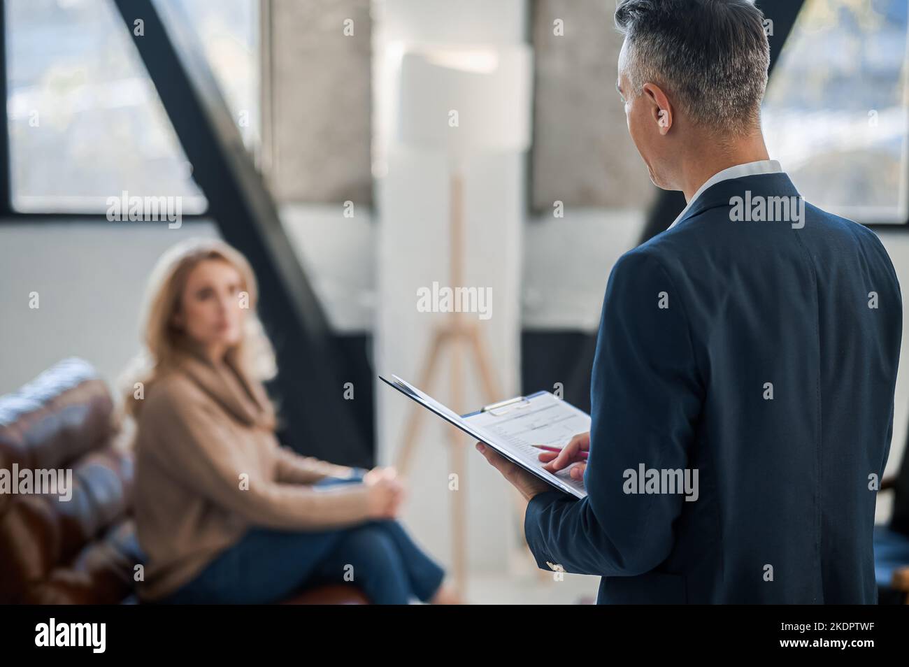 Psychologist taking to a client and making notes Stock Photo - Alamy