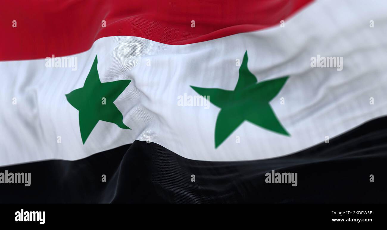 Close-up view of the Syria national flag waving in the wind. The Syrian Arab Republic is a ...