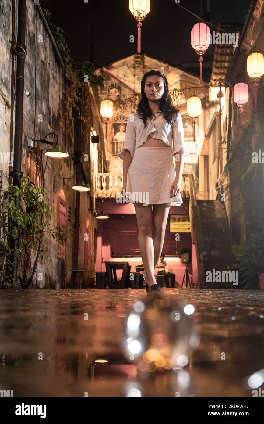 Vertical portrait of a asian woman standing next to a crystal ball in ...