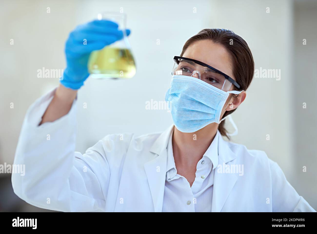 Applying scientific principles to test her theories. a female scientist ...