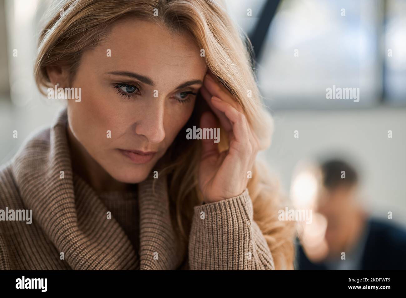 Blonde woman looking stressed and upset Stock Photo - Alamy