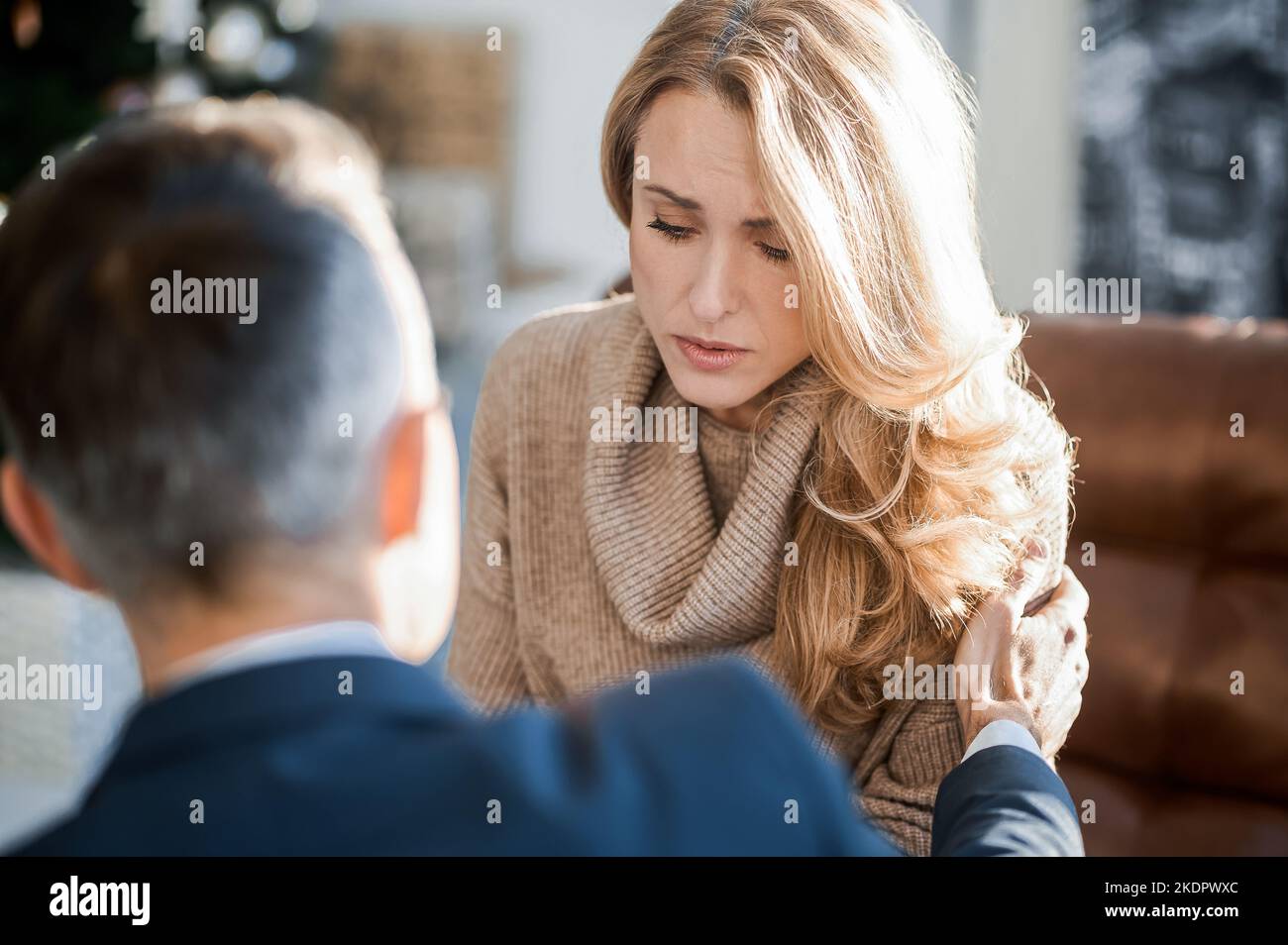 Psychologist talking to a client and looking friendly Stock Photo - Alamy