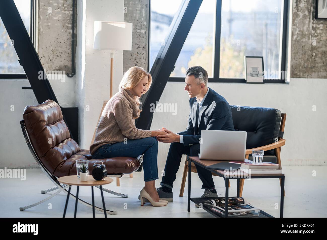 Psychologist talking to a client and looking friendly Stock Photo - Alamy
