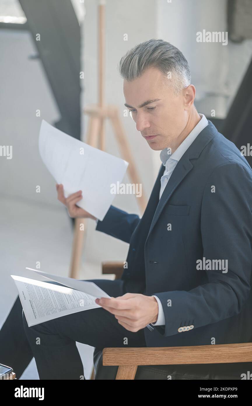 Mid aged elegant businessman working in the offie Stock Photo - Alamy