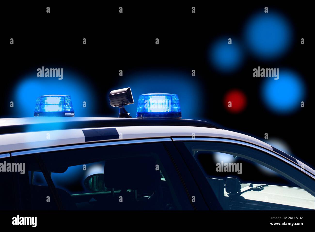 Police car at night with flashing lights and blurred bokeh blue and red ...