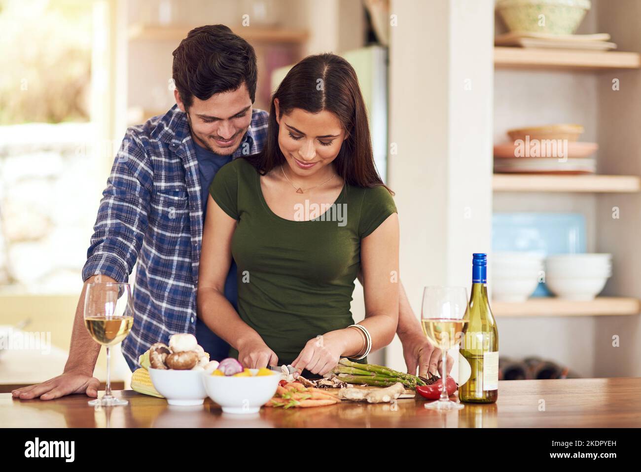 Watching the master at work. a young couple preparing dinner together ...
