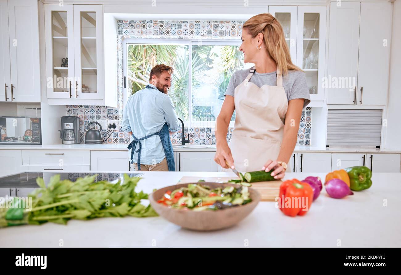 Cooking, happy and couple with vegetables and salad in a home kitchen ...