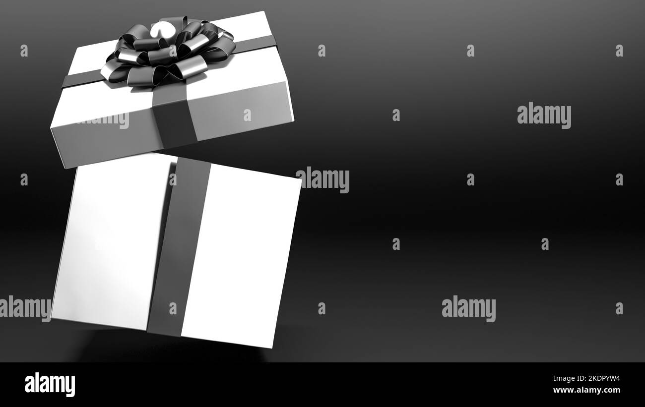 Falling white gift box with black ribbon and bow isolated on black ...