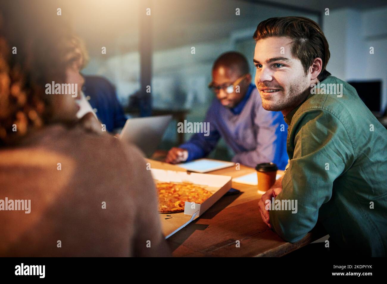 Fueling up for a brainstorming session. a team of young businesspeople ...