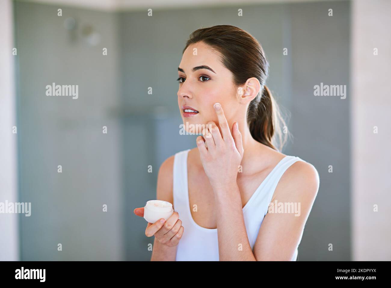 Making Sure Her Skin Stays Smooth And Flawless An Attractive Young Woman Applying Cream To Her
